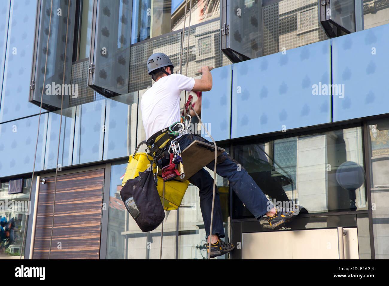 Climber wash windows and glass facade of the skyscraper Stock Photo - Alamy