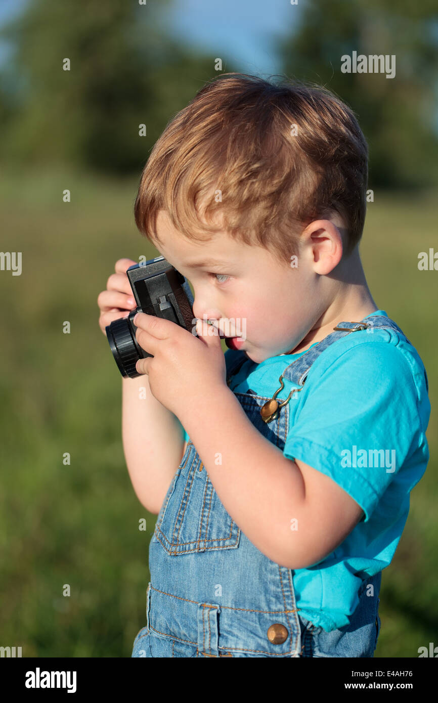 Little child taking pictures outdoor Stock Photo - Alamy