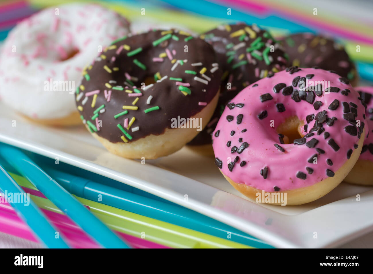 Plate of decorated doughnuts, close-up Stock Photo - Alamy