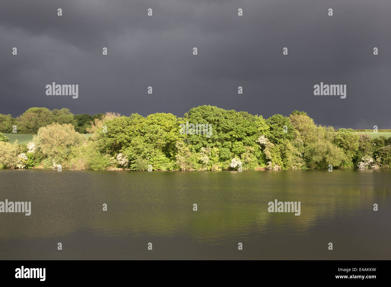 Spring storm reflections on a lake, England, UK Stock Photo - Alamy