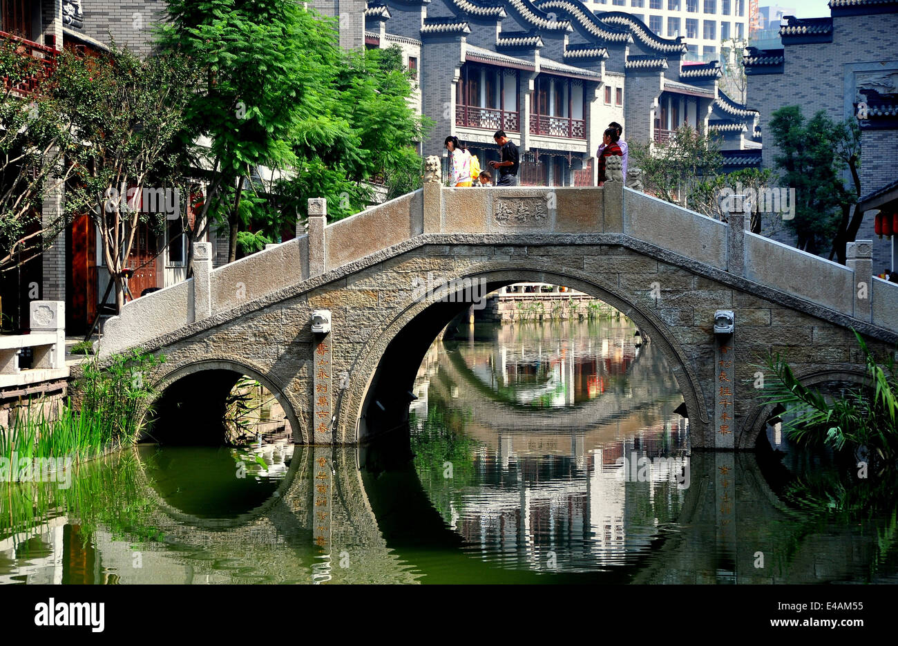 CHENGDU, CHINA: A serene three arched bridge spans one of the waterways ...