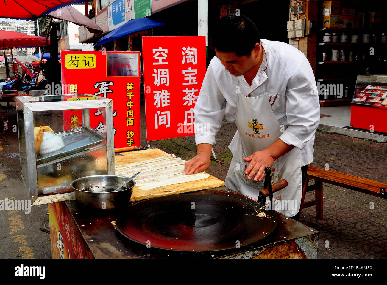 PENGZHOU, CHINA: Chef preparing dough for Chinese fried pizza rolls at ...