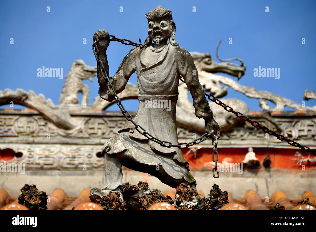 PENGZHOU, CHINA: A sculpted ghost statue atop the roof of the great ...