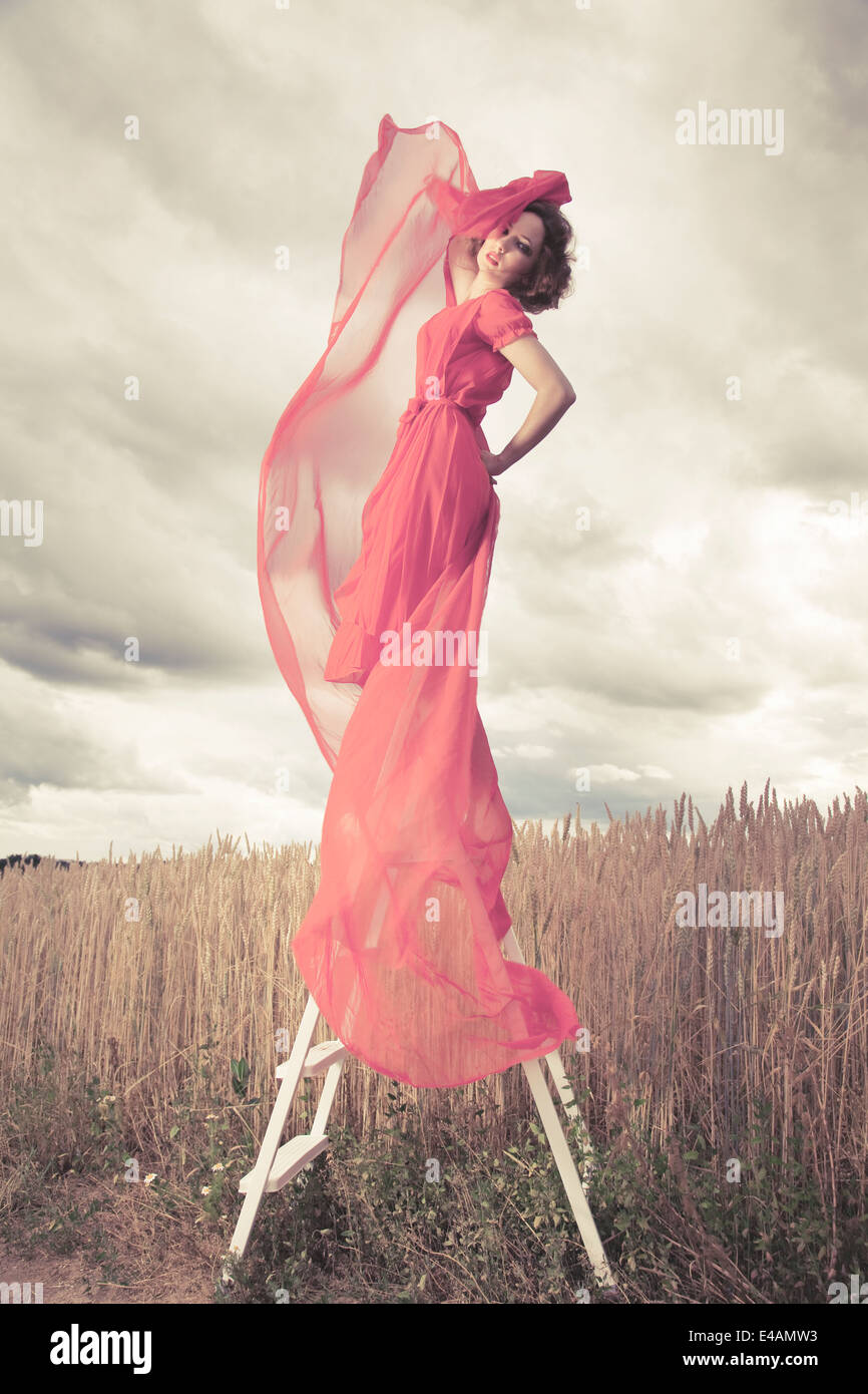 Beautiful woman in red dress background Stock Photo - Alamy