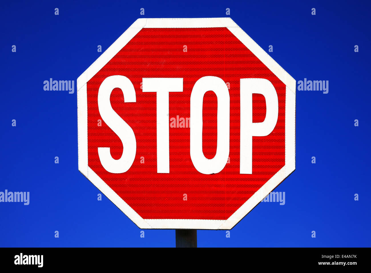 Red stop sign with a clear blue sky background Stock Photo - Alamy