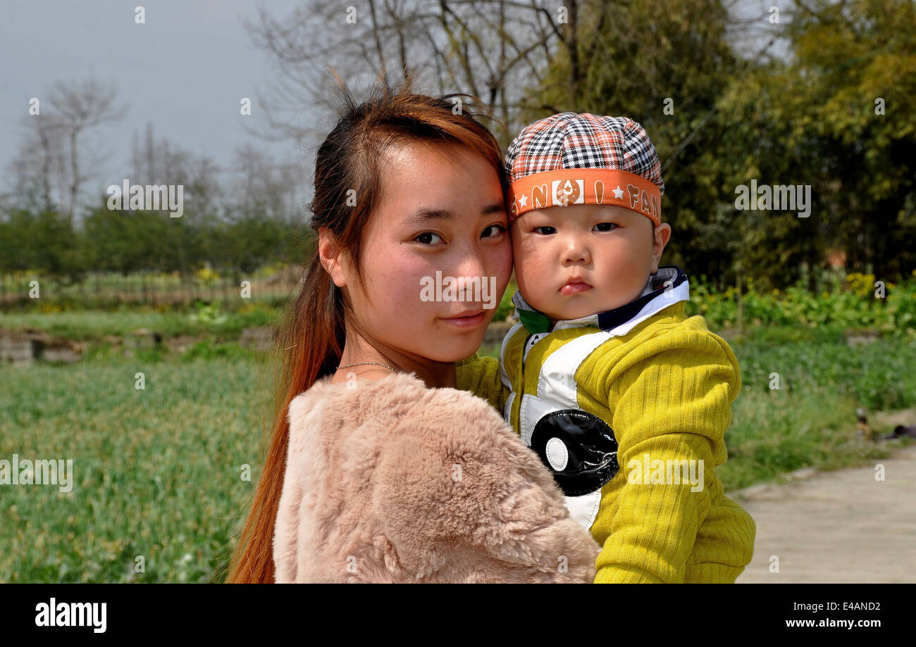 Pengzhou, China: Young Chinese mother holding her baby son at a Sichuan ...