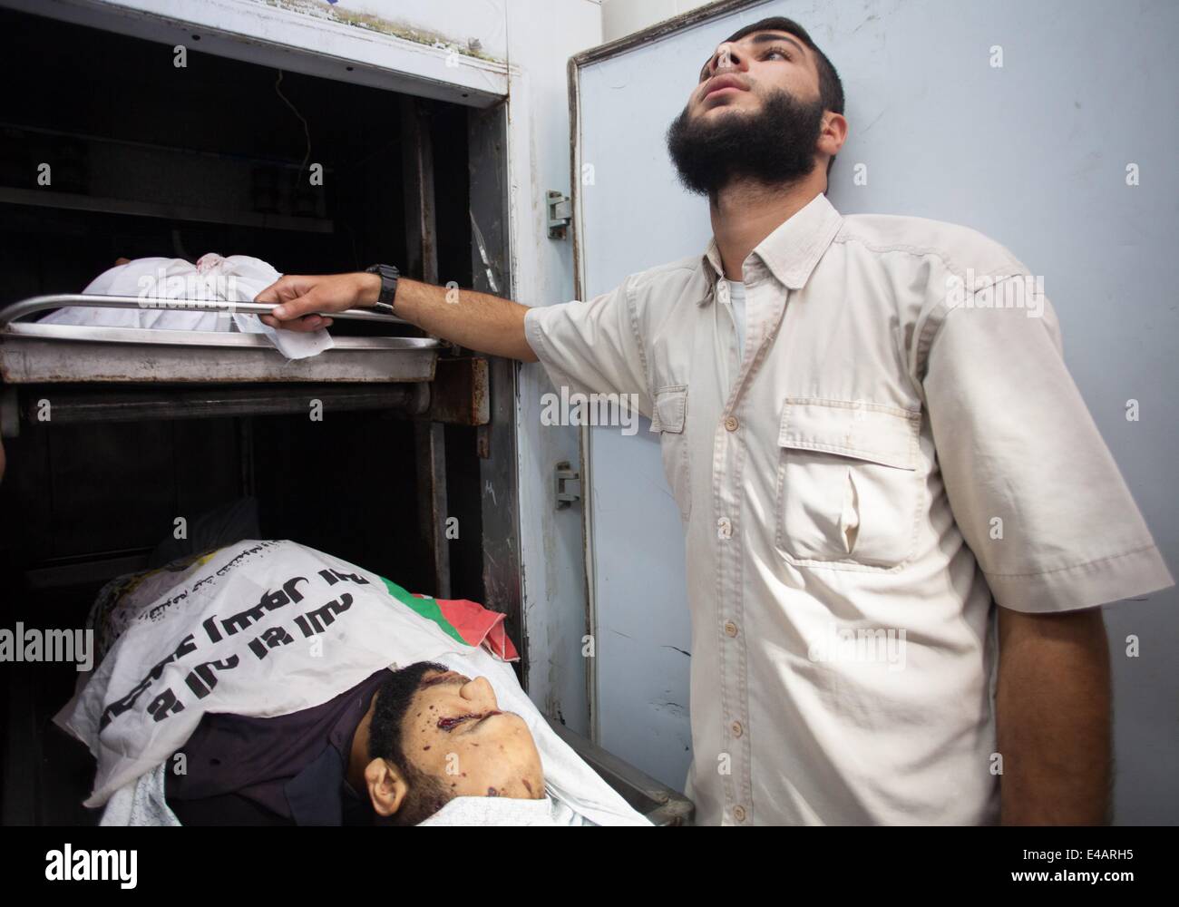Gaza Strip. 7th July, 2014. A Palestinian man mourns over the body of ...