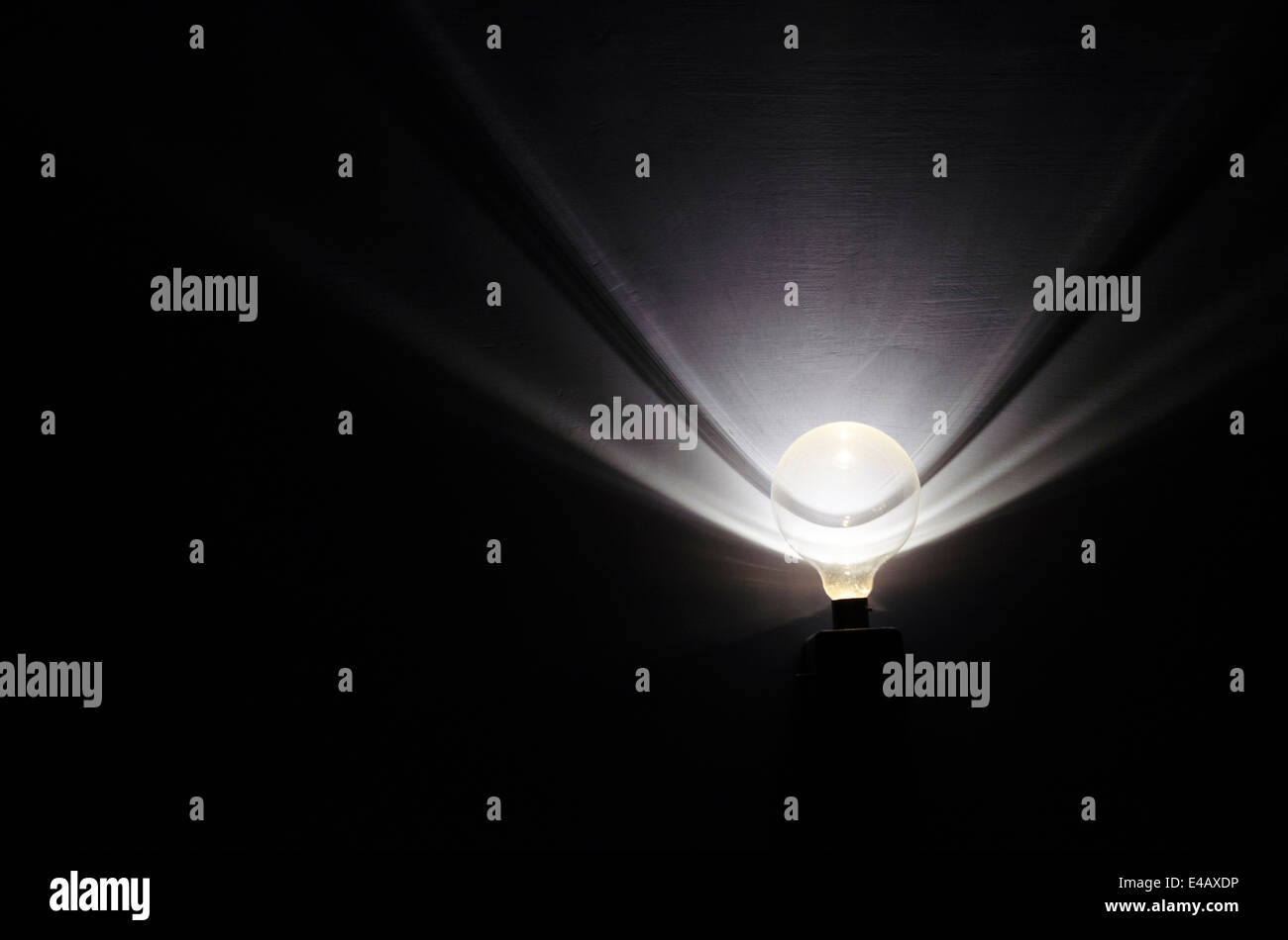 lightbulb lighting up the dark Stock Photo - Alamy