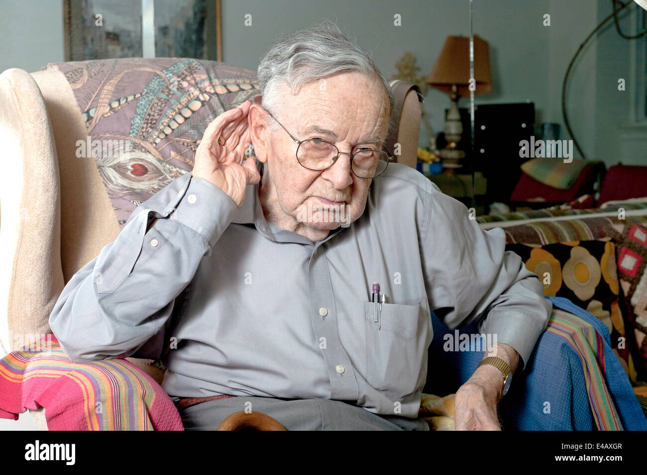 A senior man making a repeat or speak louder gesture with his hand ...