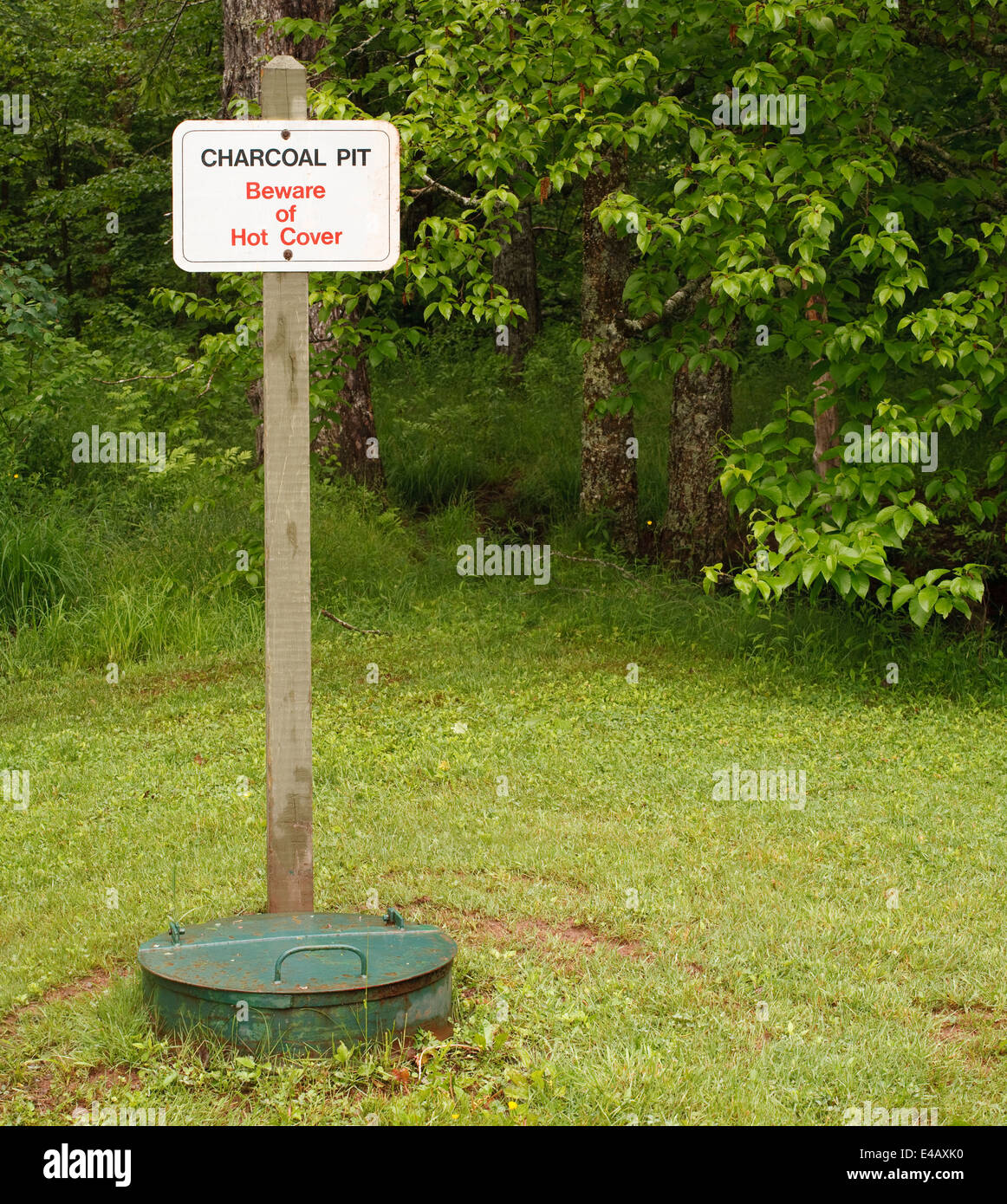 Charcoal pit and beware of hot cover sign in park setting Stock Photo ...