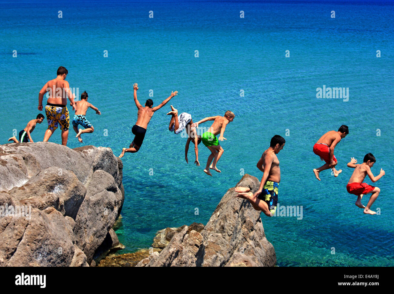Boys diving from the rocks next to an Early Christian Basilica, at ...