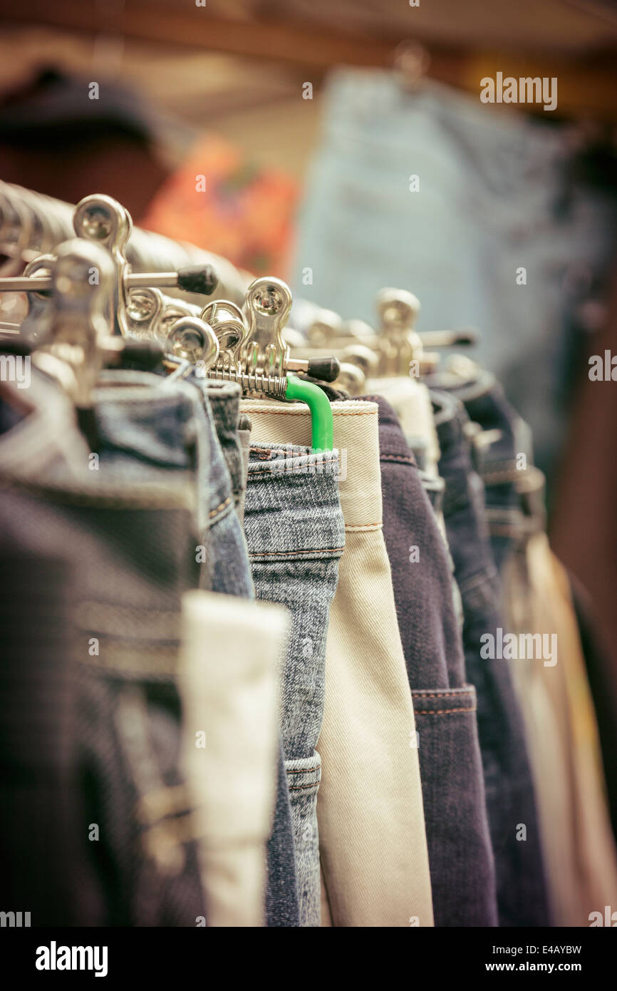 clothes on a rack on a flea market Stock Photo - Alamy