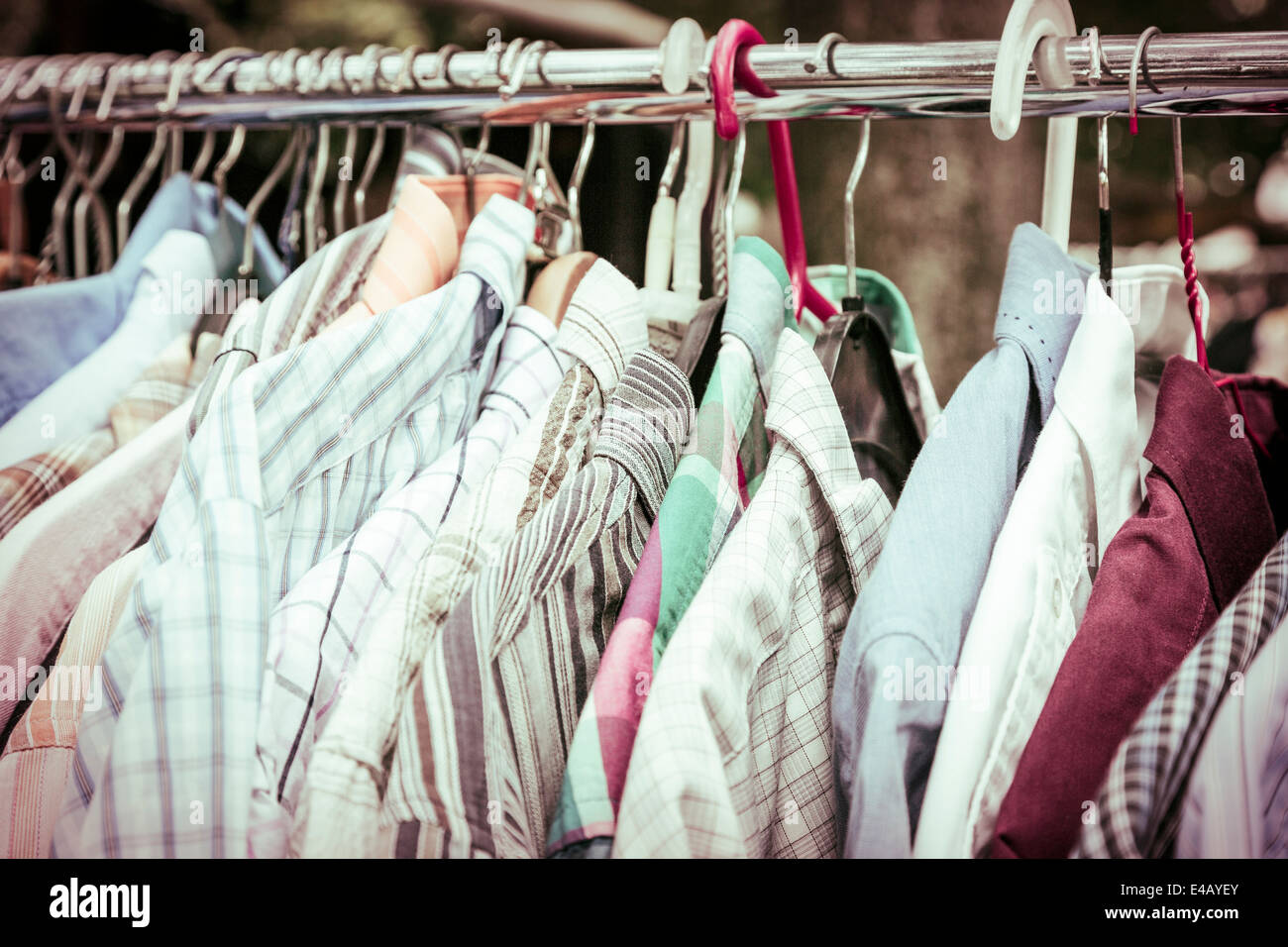 clothes on a rack on a flea market Stock Photo - Alamy