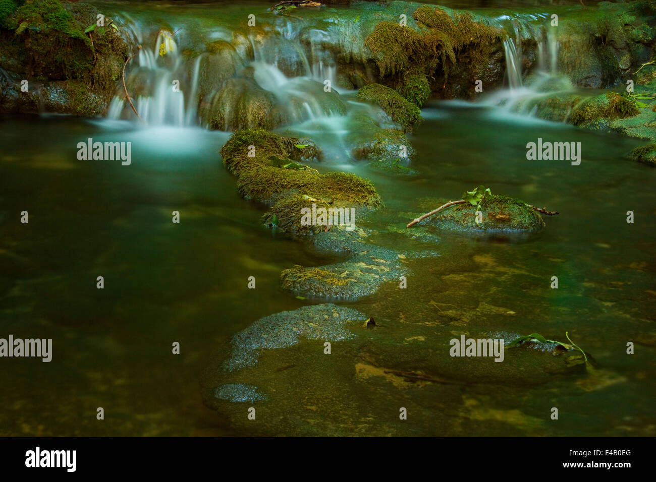 little creek floating around mossy rocks, small waterfall Stock Photo ...