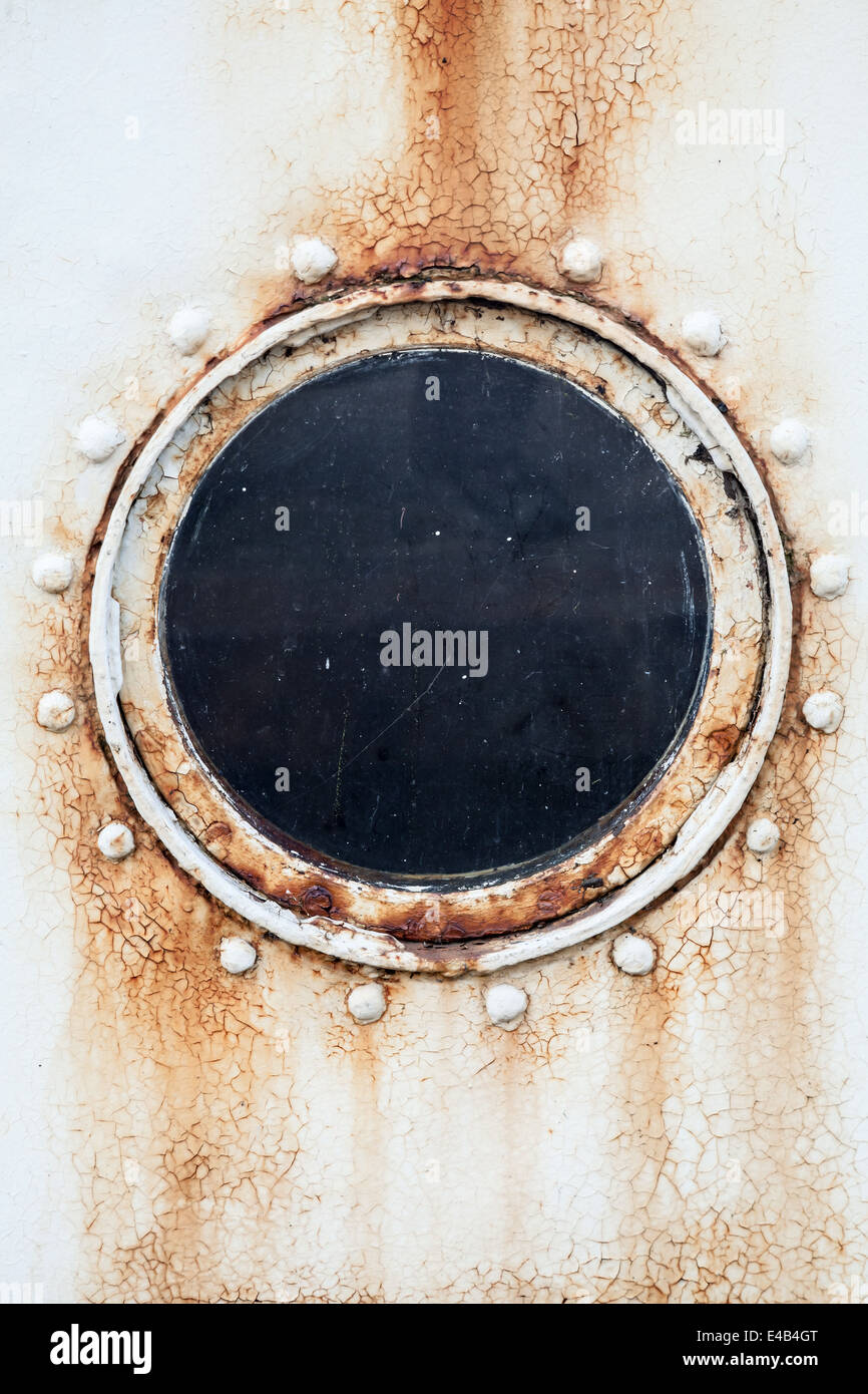 Round rusted porthole on white ship wall Stock Photo - Alamy