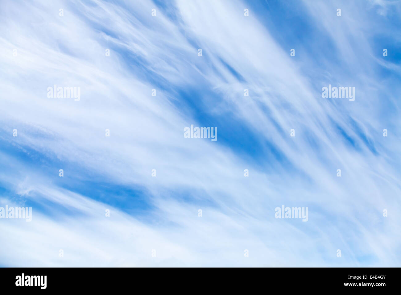 Windy clouds on the blue sky. Background photo texture Stock Photo - Alamy