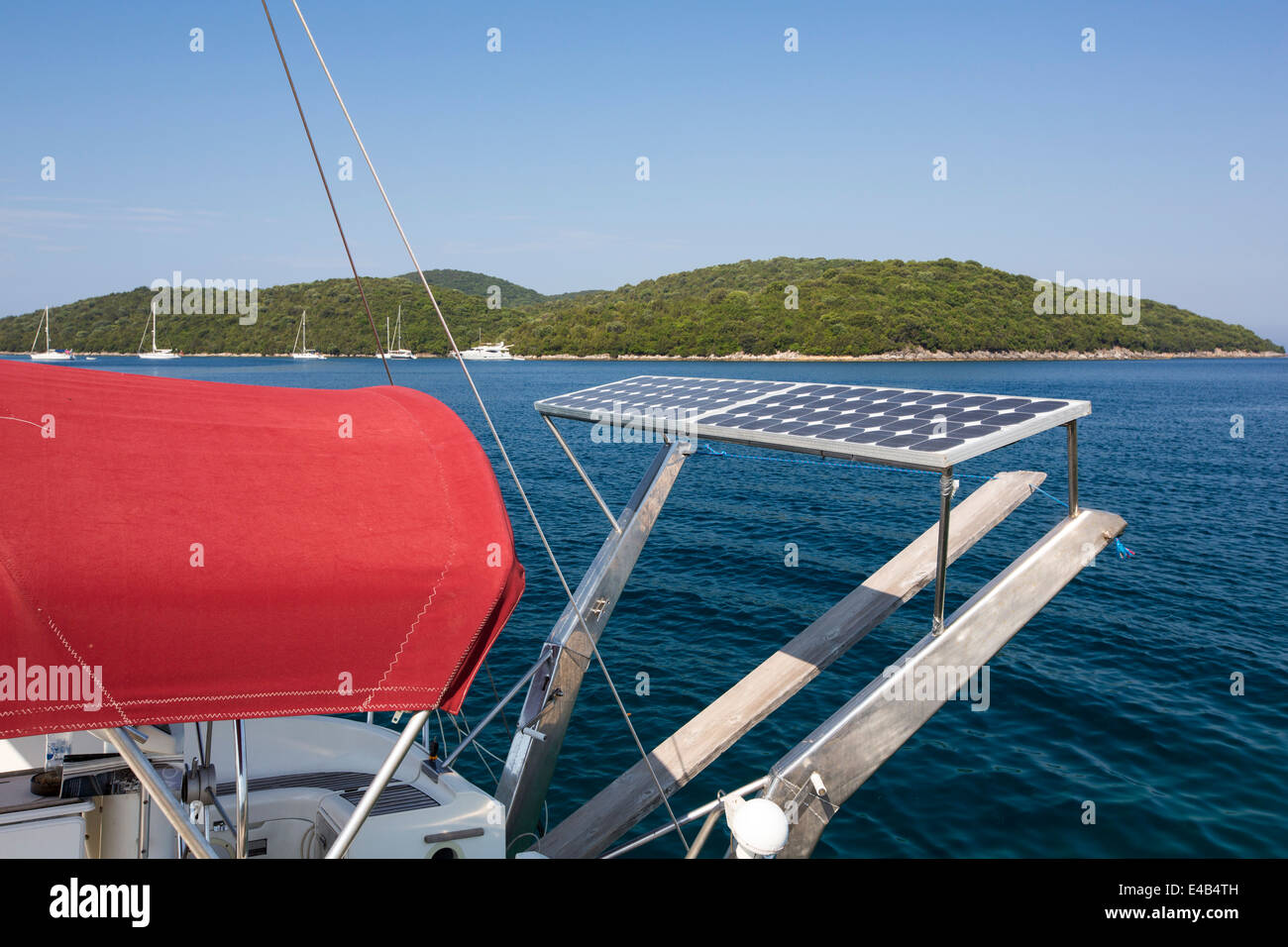 A sailor fishing by his yacht with a solar panel, Sivota, Greece Stock ...
