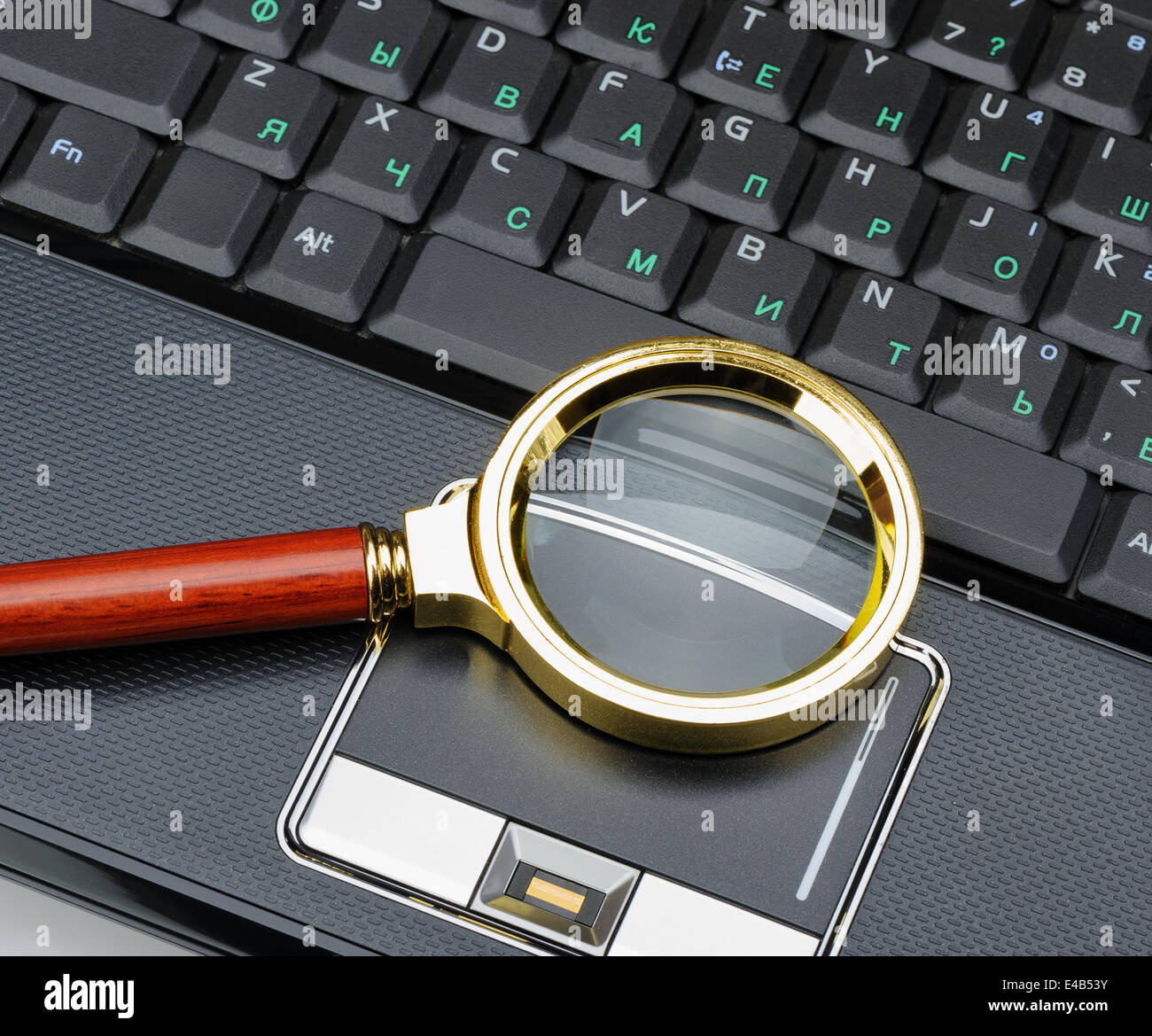 Magnifying glass and a laptop Stock Photo - Alamy