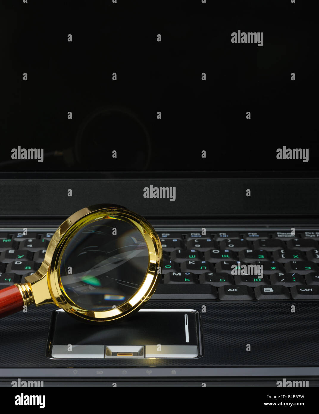 Magnifying glass and a laptop Stock Photo - Alamy