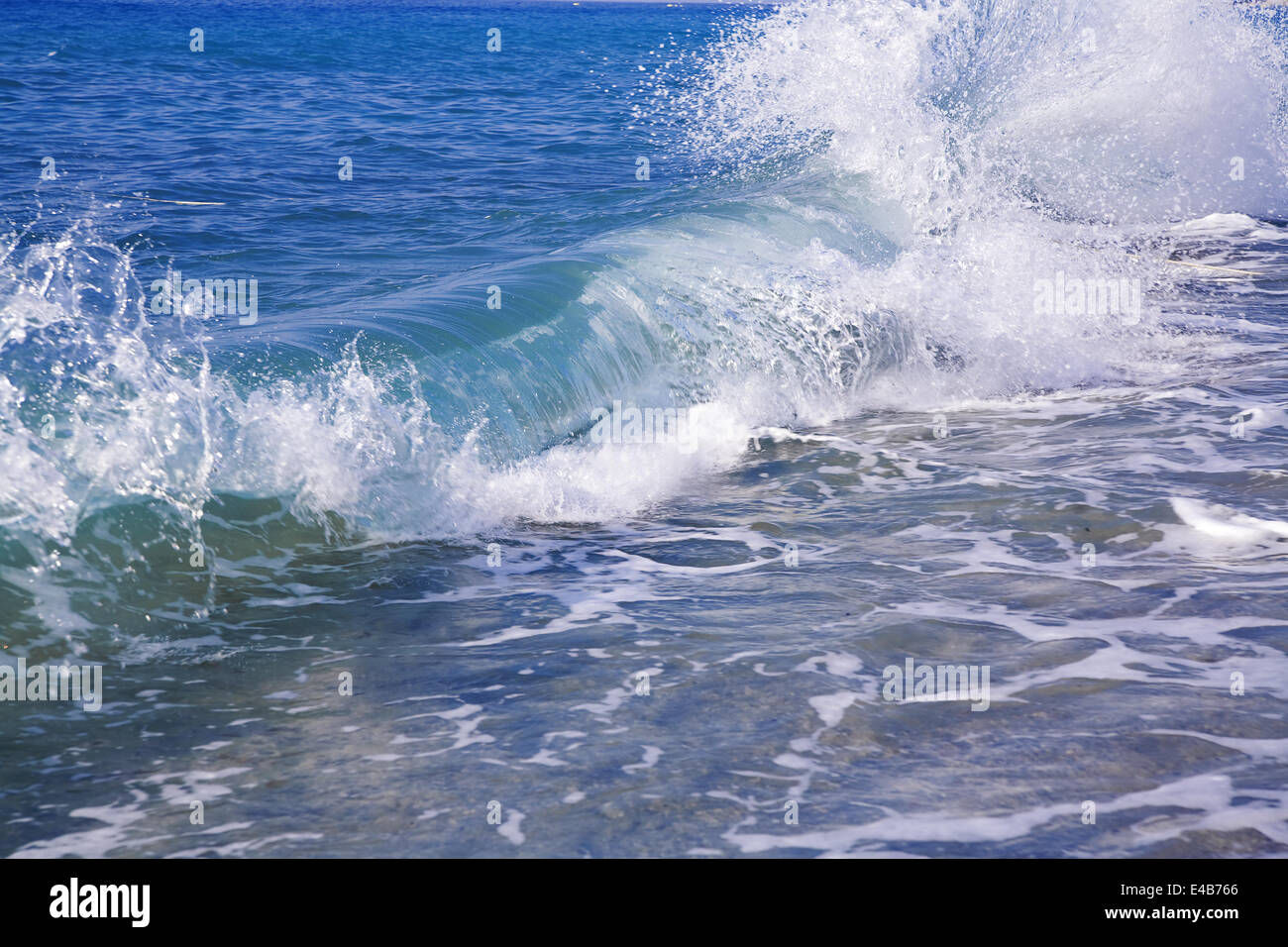 powerful blue foamy wave runs in a coast Stock Photo - Alamy