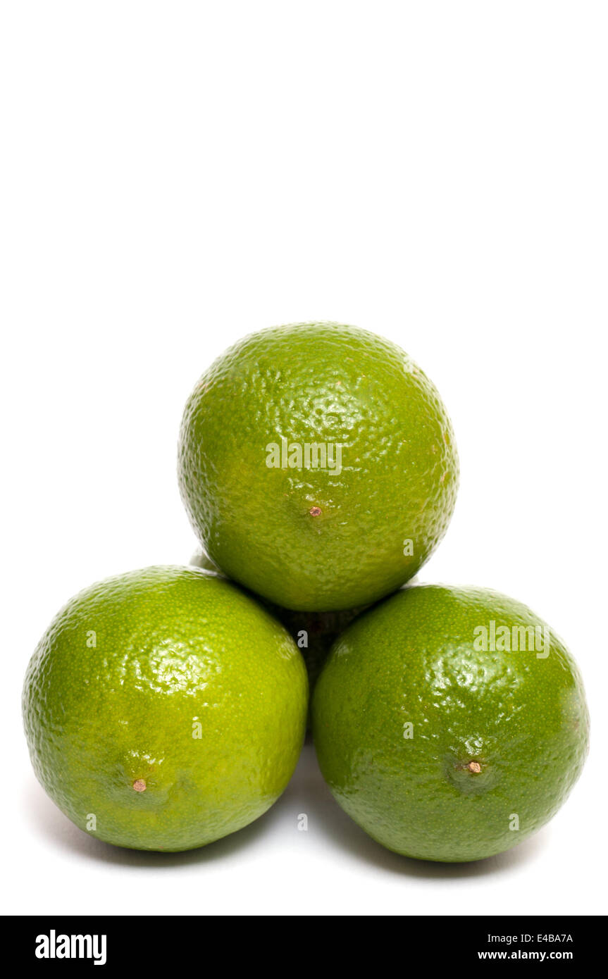 Three green limes Stock Photo - Alamy