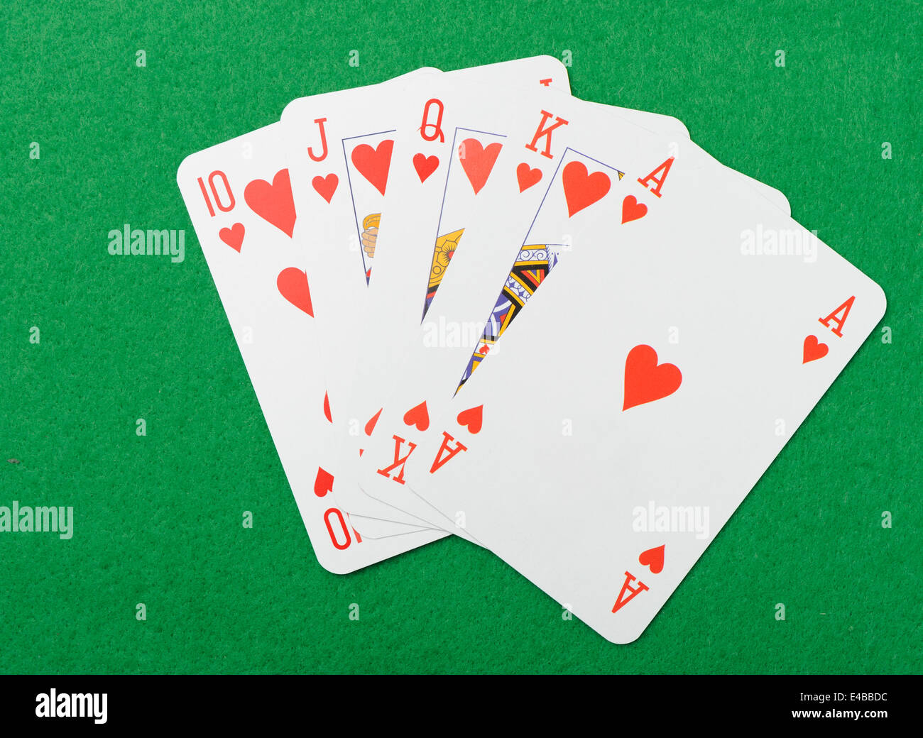Playing cards on a green background Stock Photo - Alamy