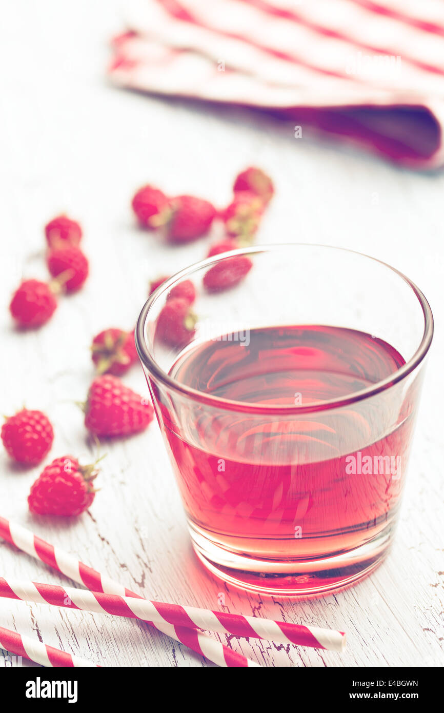 raspberry juice on white table Stock Photo - Alamy