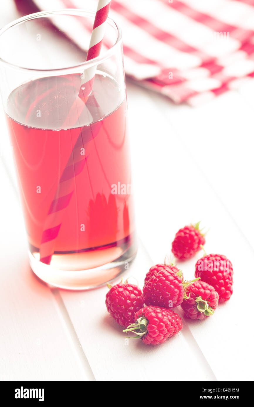 raspberry juice on white table Stock Photo - Alamy
