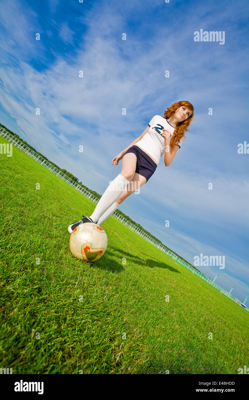 Beautiful redhead girl plays soccer Stock Photo - Alamy