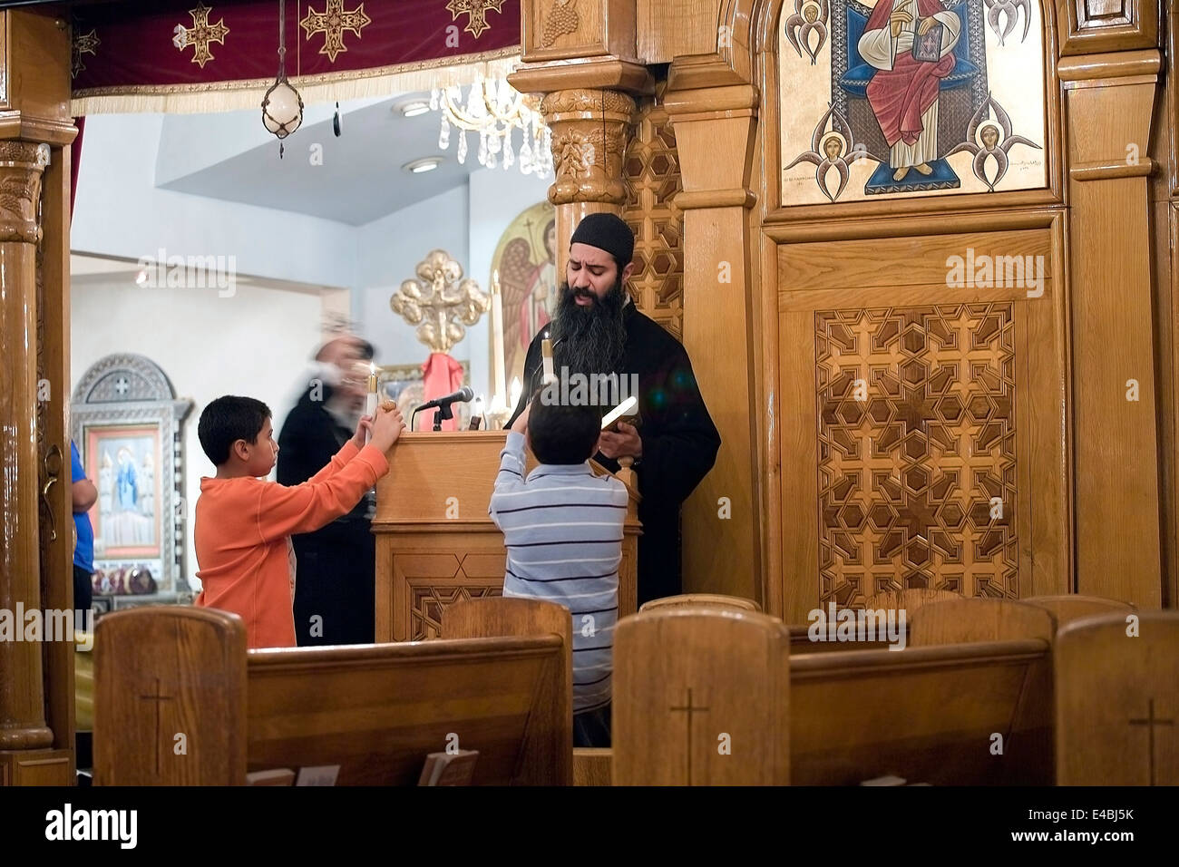 A church priest guides parishoners during Vespers prayer night at the ...
