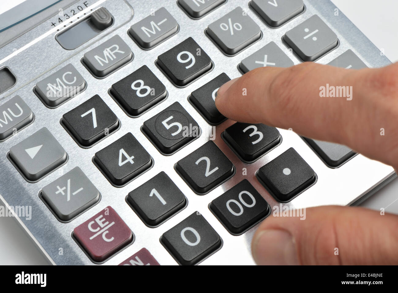 The calculator and a hand of the man Stock Photo - Alamy