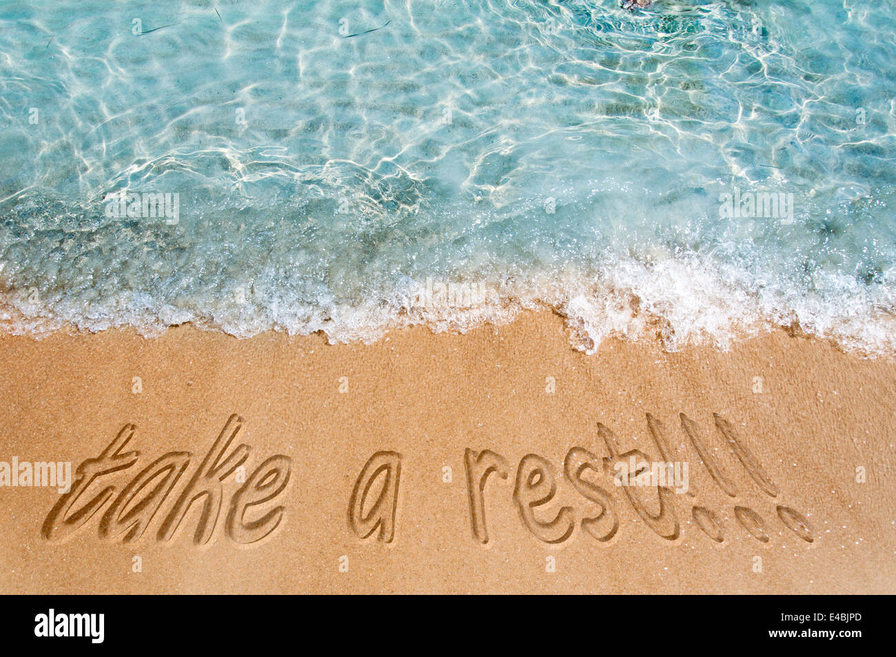 Take a rest sign on the beach sand Stock Photo - Alamy