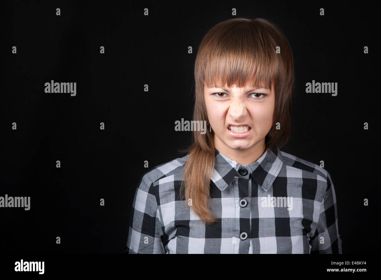 Young beautiful girl snarls Stock Photo - Alamy