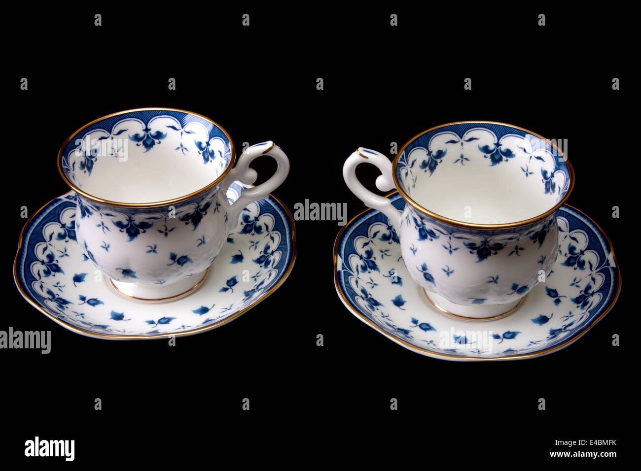 Two tea cups on saucer Stock Photo - Alamy
