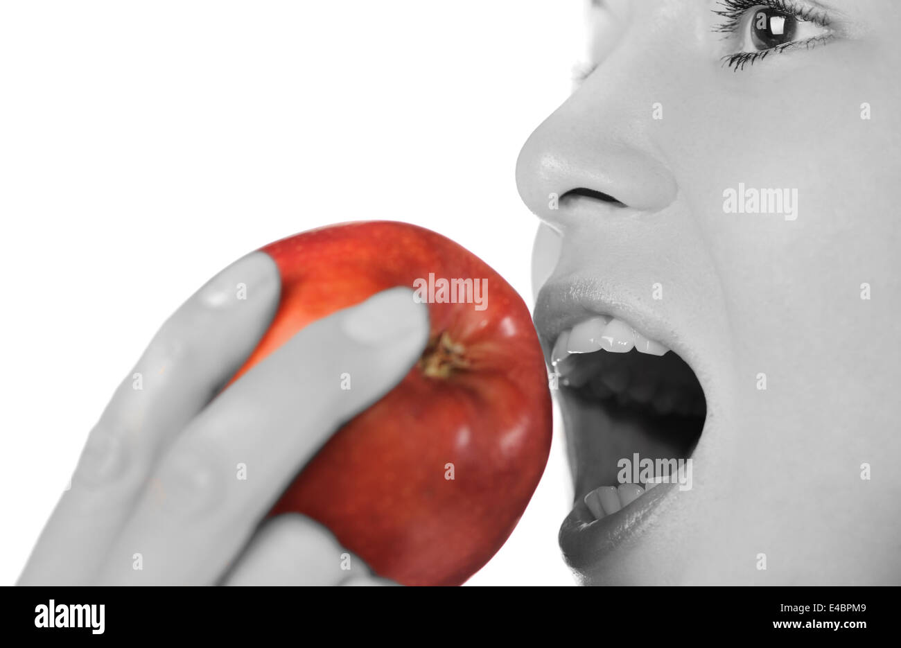 The girl taking a bite an apple Stock Photo - Alamy