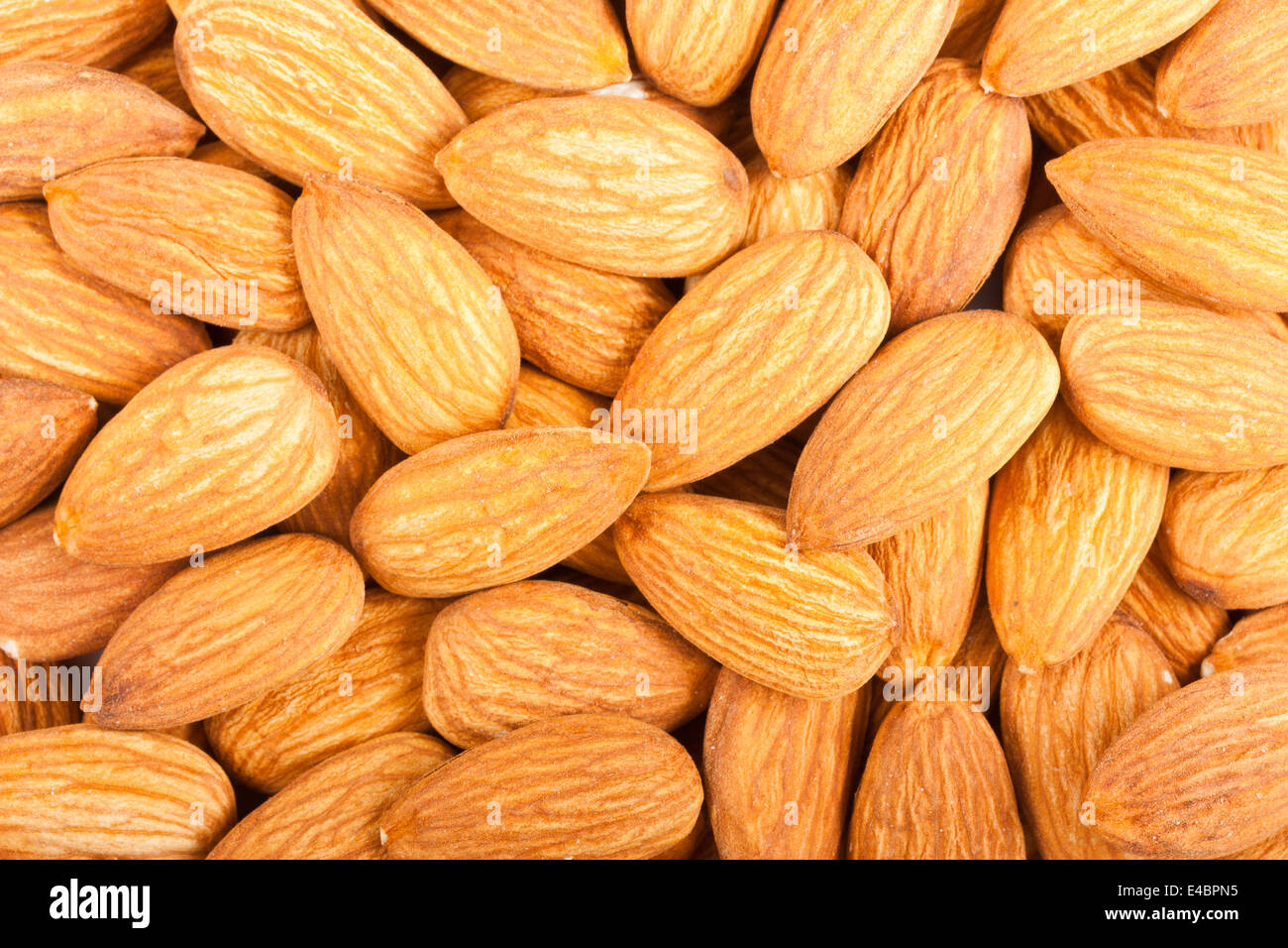 Whole almond nuts closeup Stock Photo - Alamy
