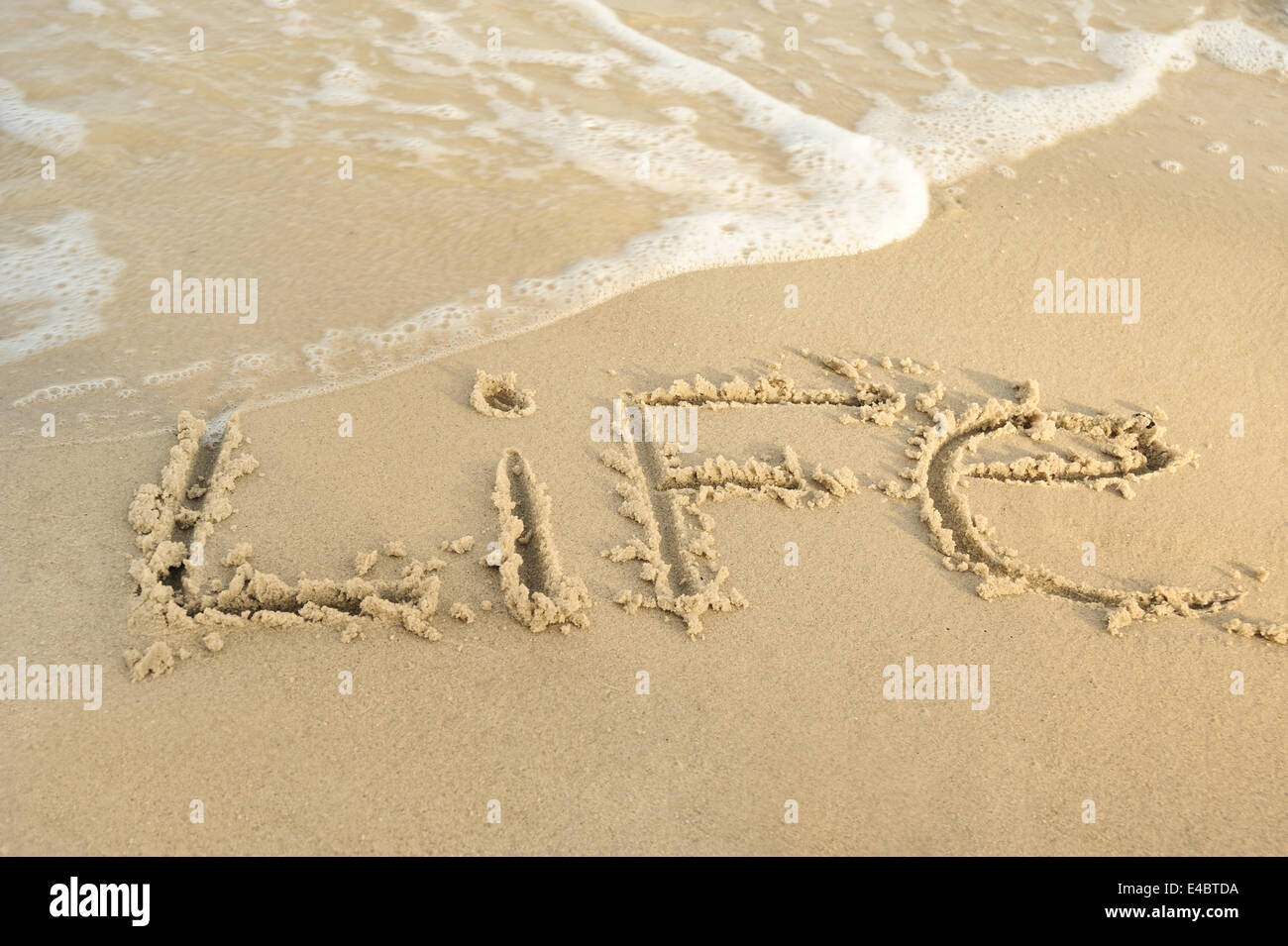 Inscription life on sand Stock Photo - Alamy