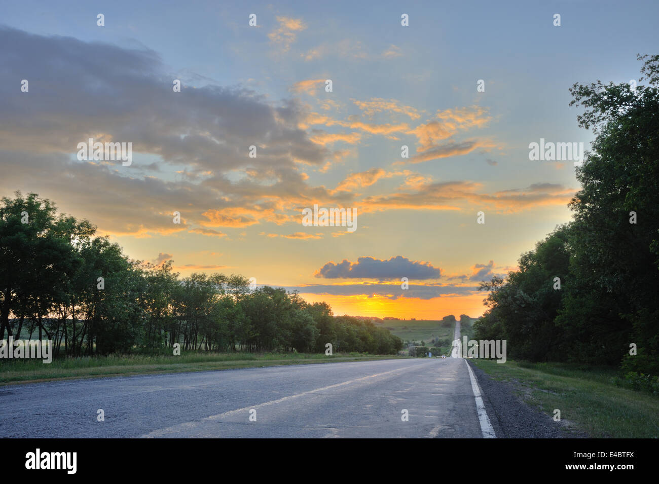 Road and sunset Stock Photo - Alamy
