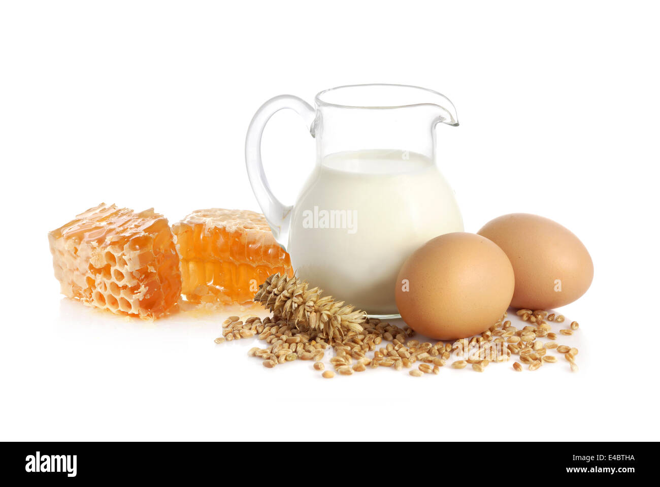 Milk, wheat seeds, eggs and honey Stock Photo - Alamy
