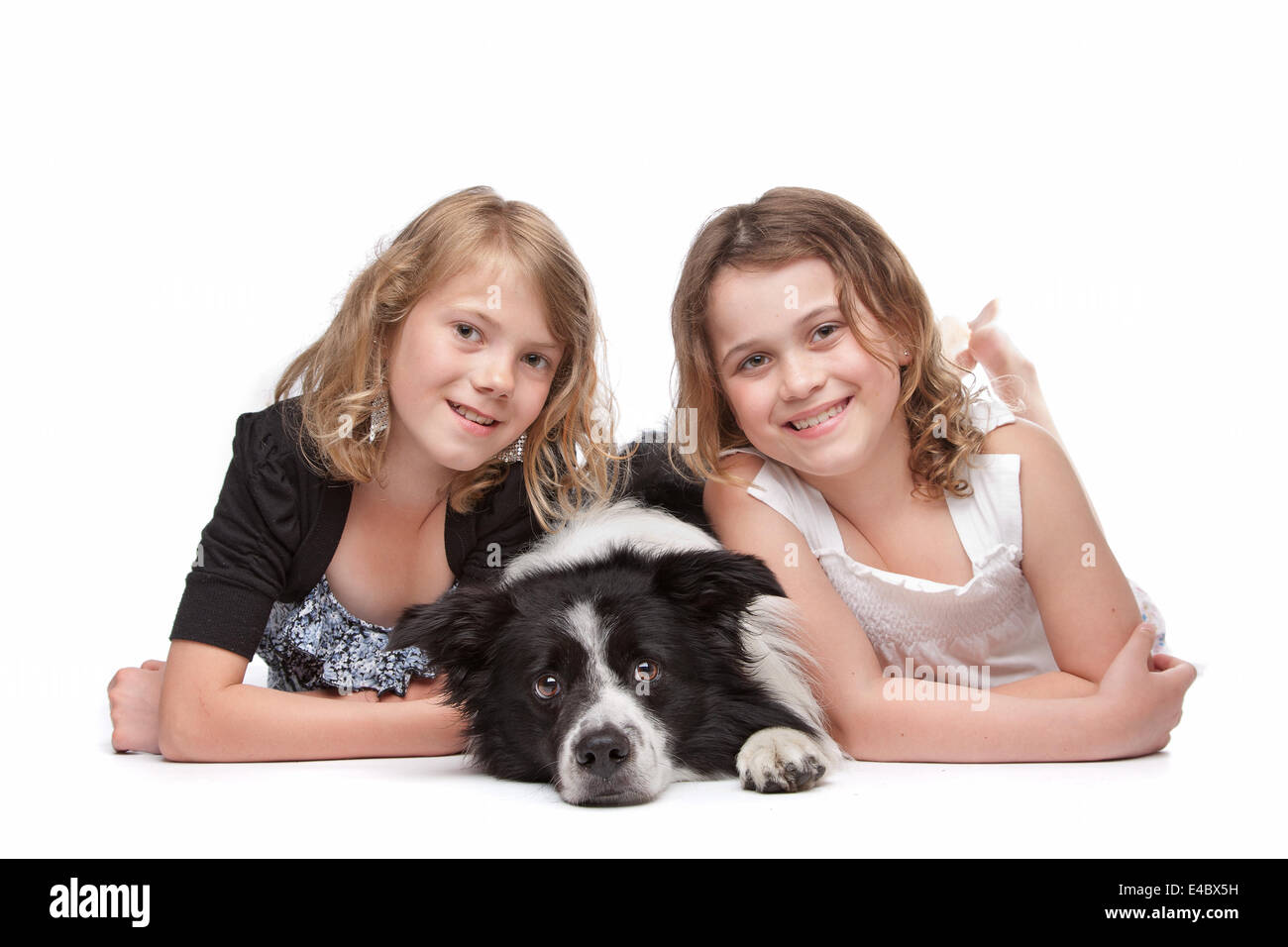 Two girls and a dog Stock Photo - Alamy