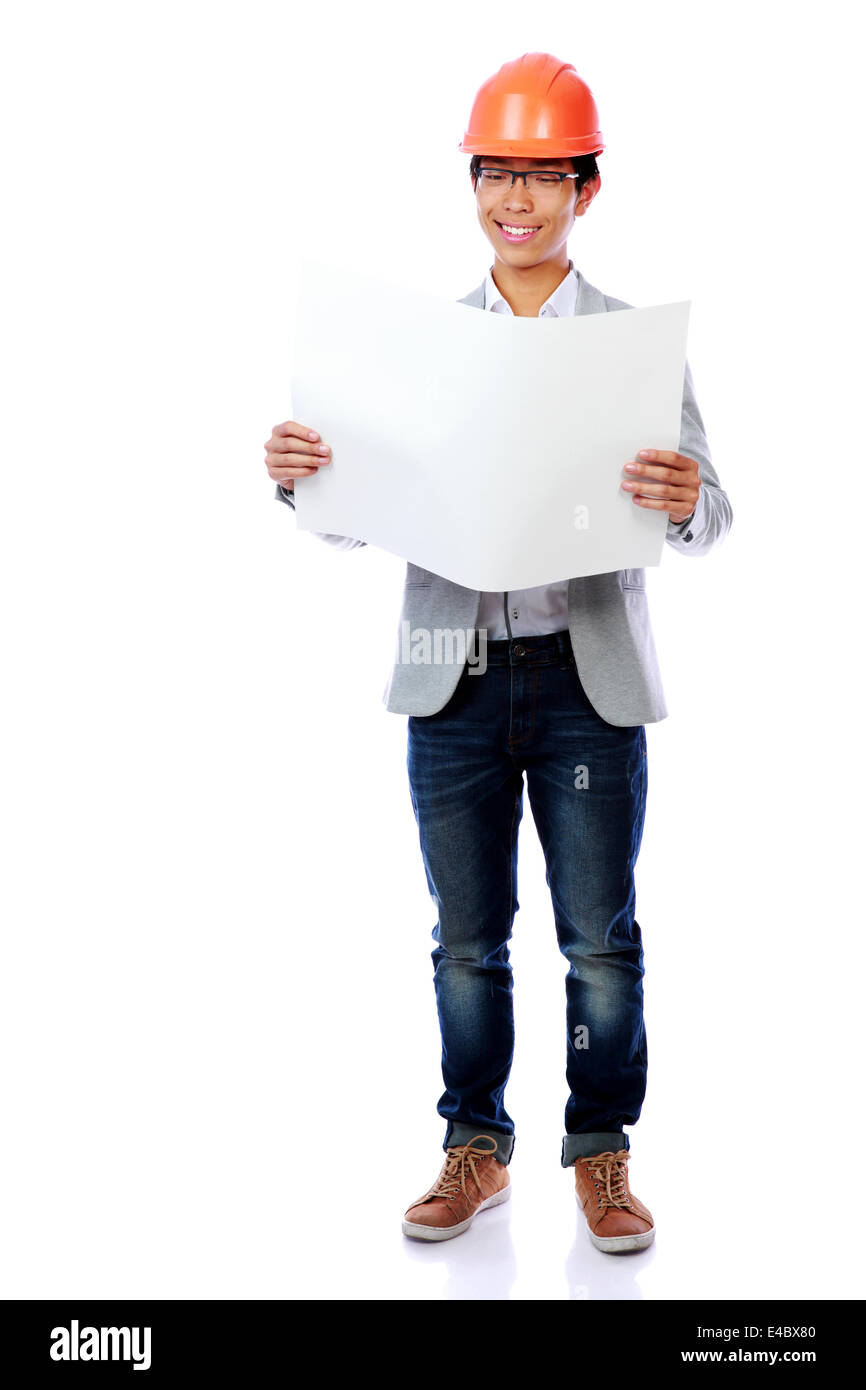 Asian young man wearing a hardhat looking at blueprint paper Stock ...