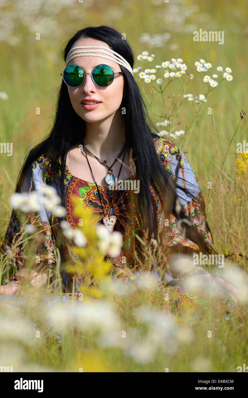 hippie girl on a flowering field Stock Photo - Alamy