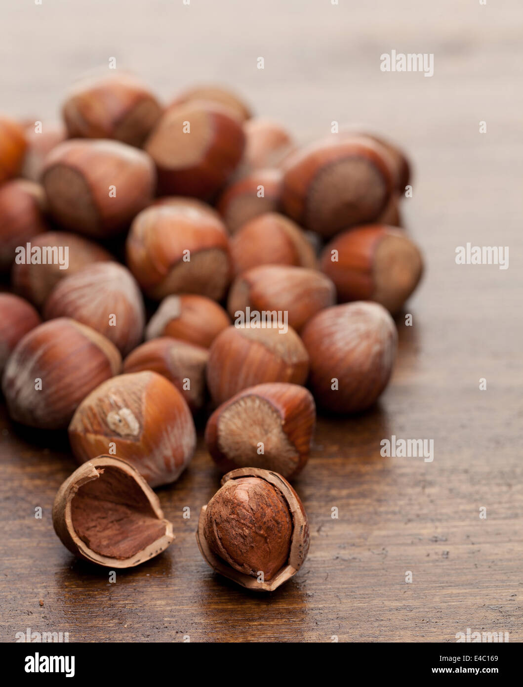 Nuts at wooden table Stock Photo - Alamy
