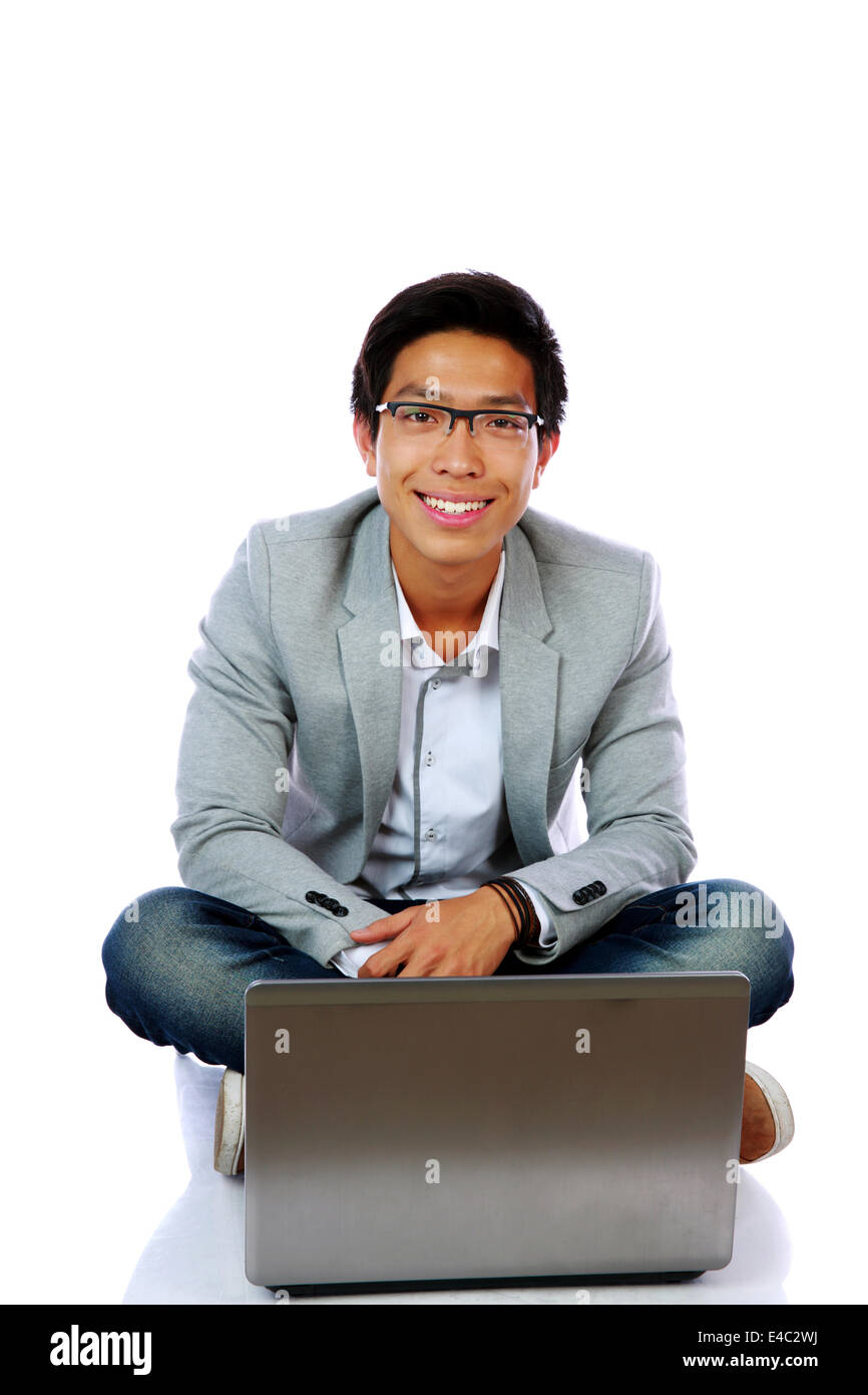 Smiling asian man sitting on the floor with laptop Stock Photo - Alamy