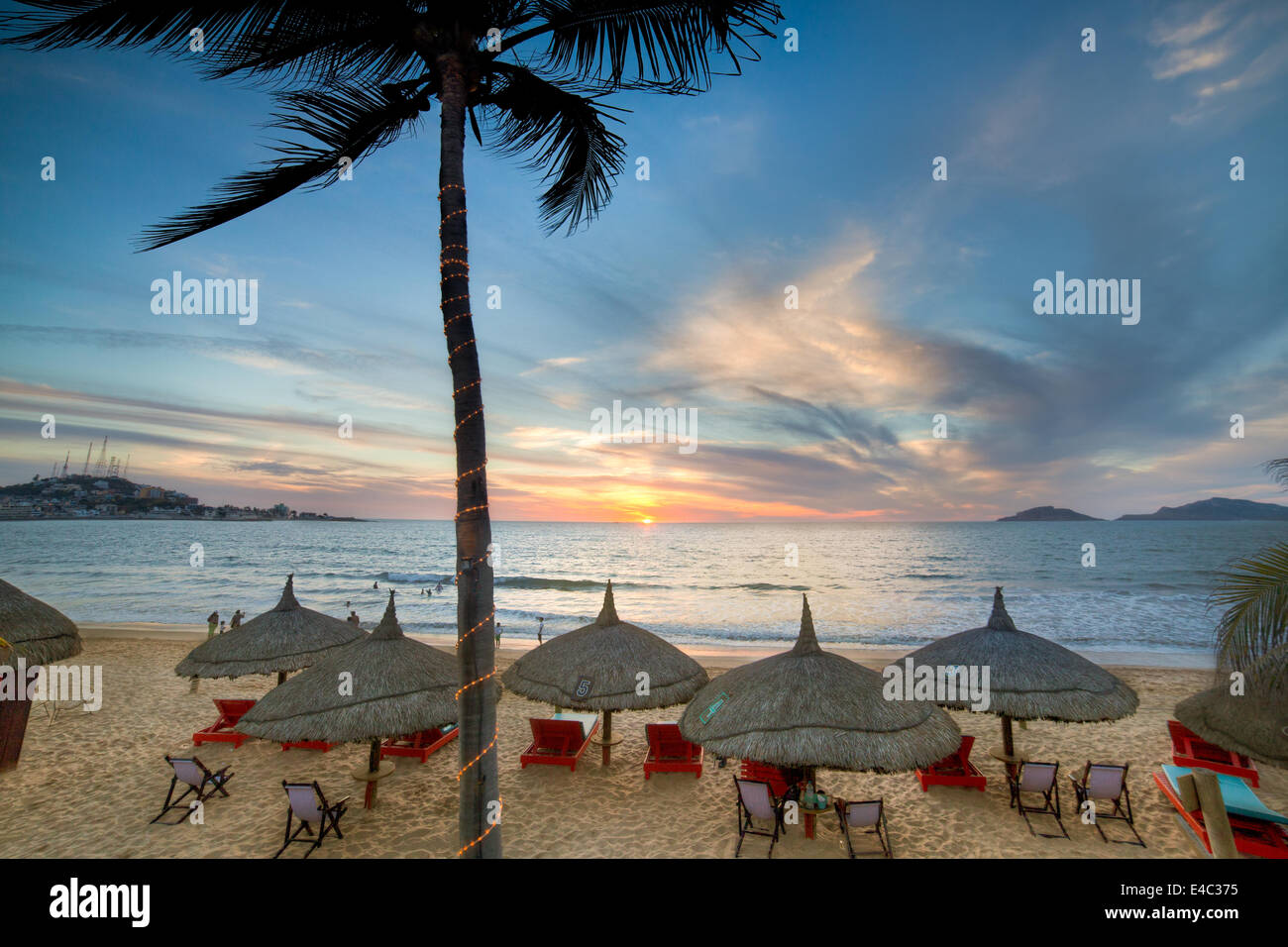 Sunset and palapas on the beach at sunset in Mazatlan, Sinaloa, Mexico ...