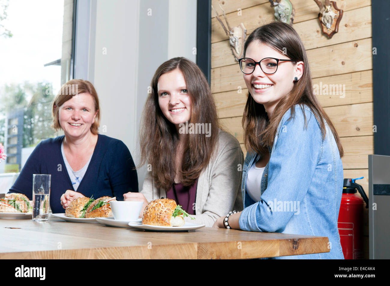 Three women at a restaurant sitting hi-res stock photography and images ...