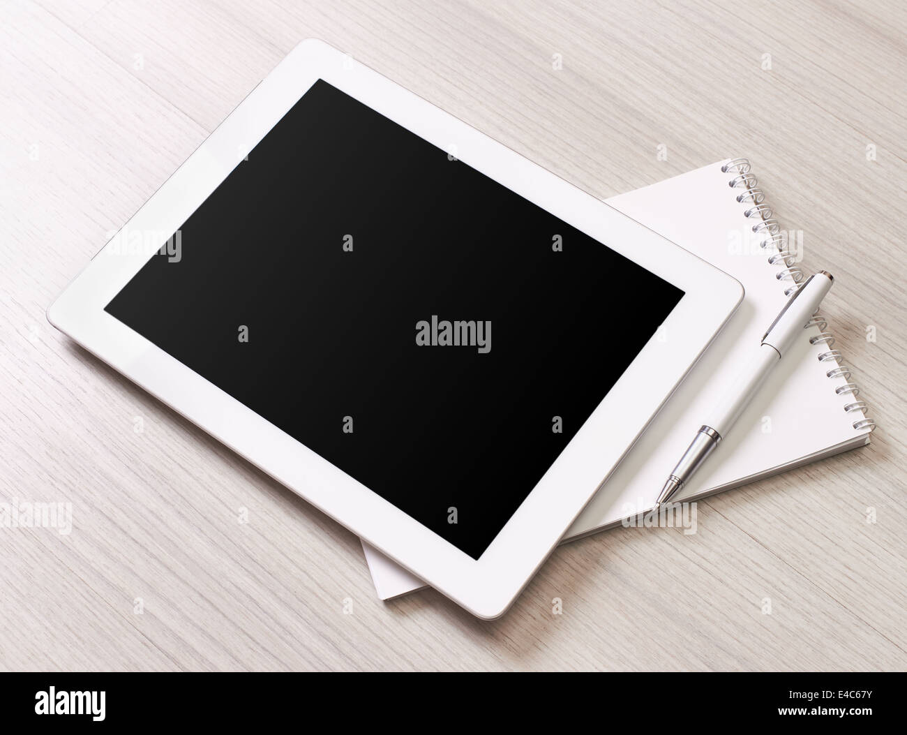 Digital tablet on wooden tablets with notepad and pen Stock Photo - Alamy