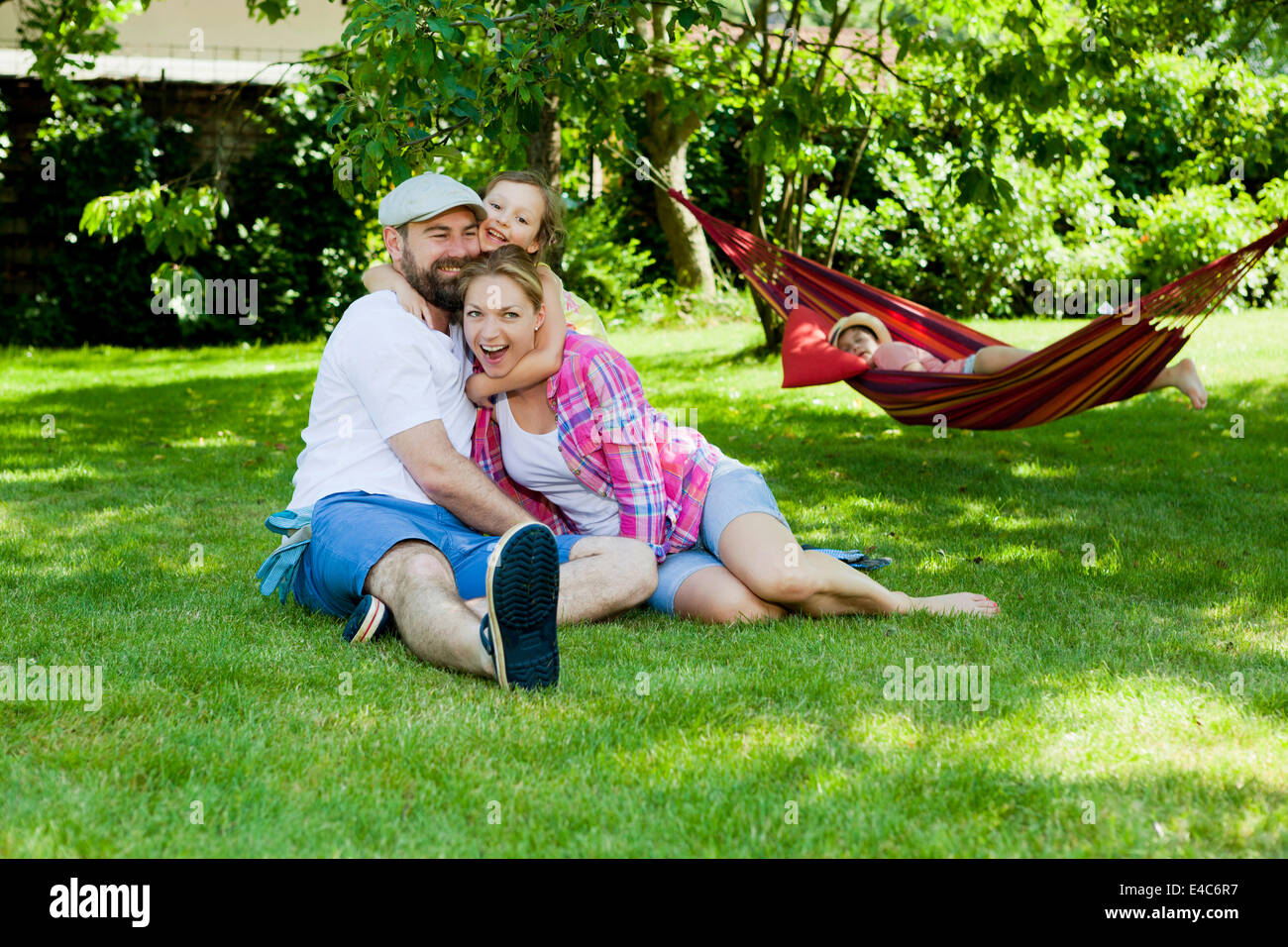Family with two children having fun in the garden, Munich, Bavaria ...