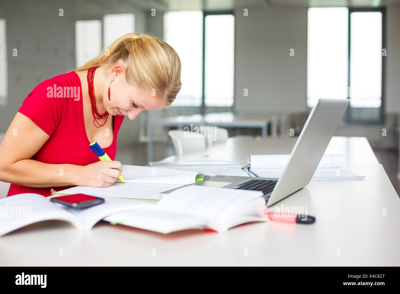 Pretty, female college student in a library Stock Photo - Alamy