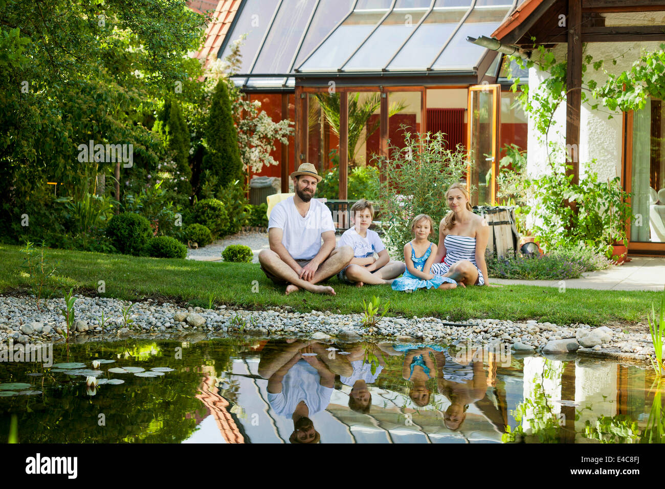 Family with two children takes a break by the pond, Munich, Bavaria ...